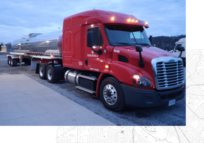 Several fuel trucks fueling up at a rack location.